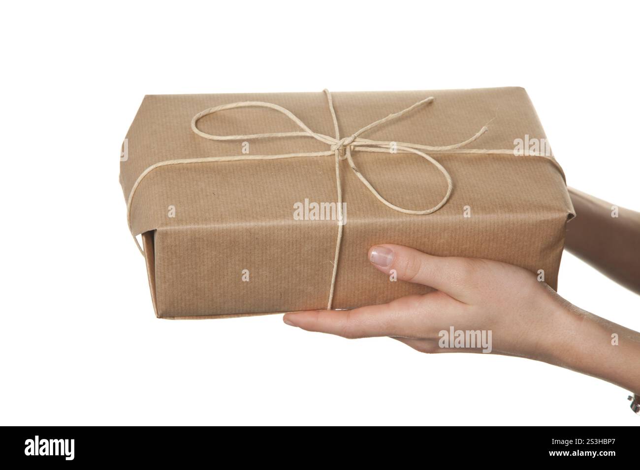 Two female hands hand over a parcel wrapped in wrapping paper Stock ...