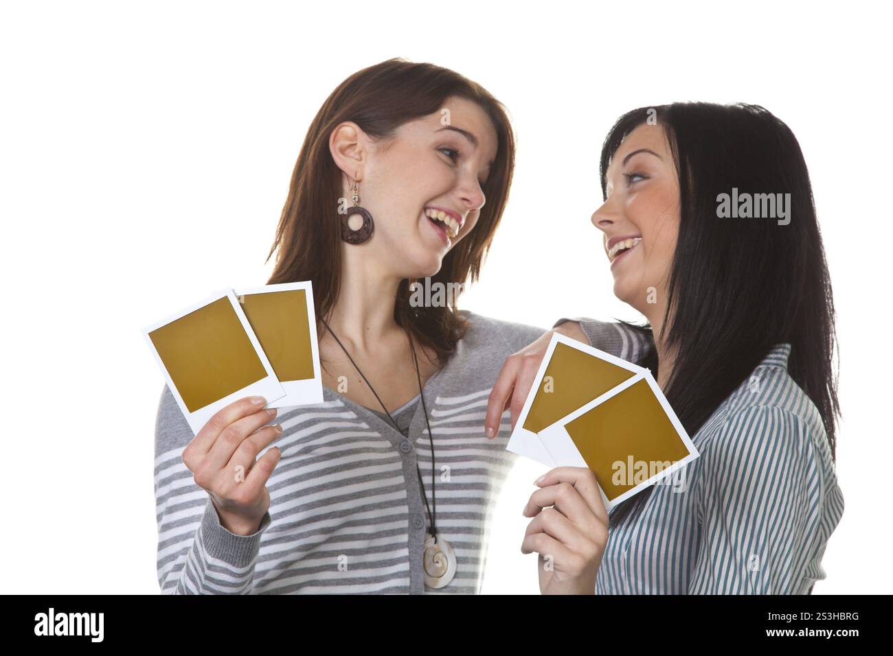 Two friends laugh at each other while playing cards Stock Photo - Alamy