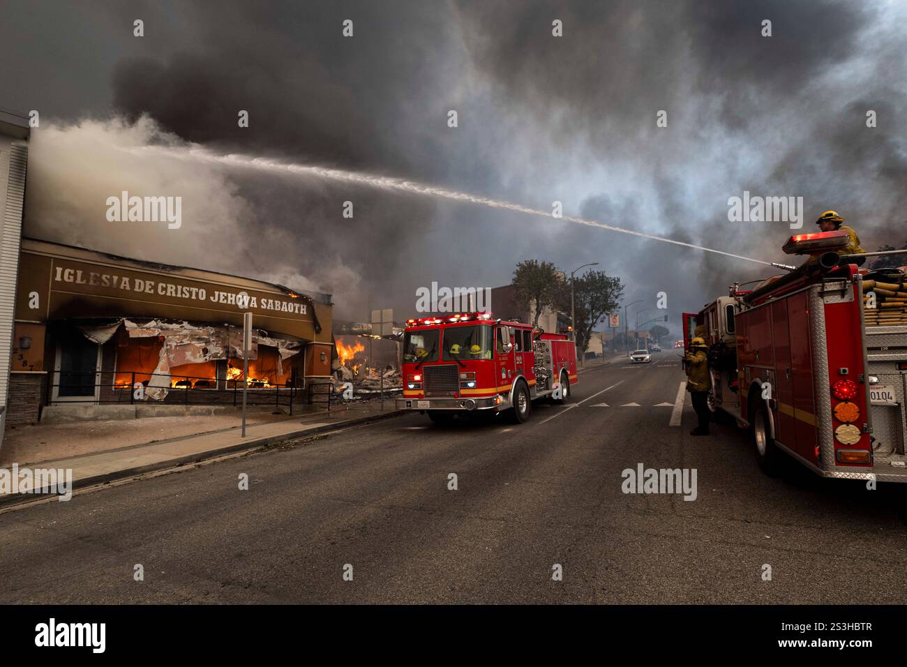 Altadena, United States. 08th Jan, 2025. LAFD Firefighters hose down a ...