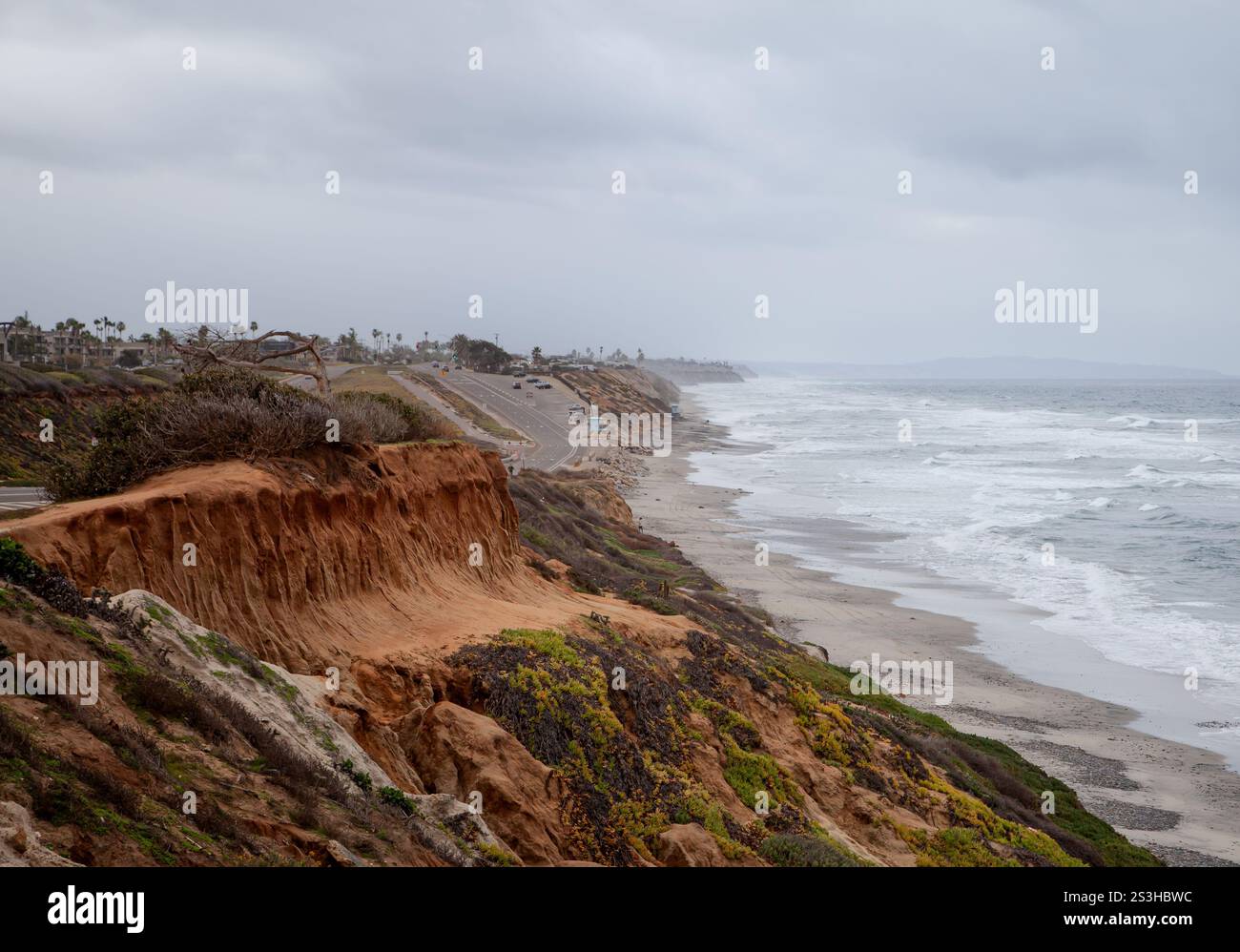 Waves crash against the sandy beach in Carlsbad, California while ...