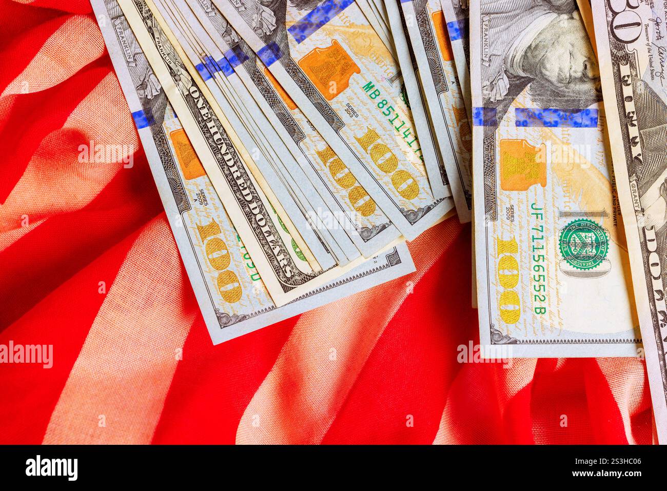 Collection of American hundred dollar bills laid on bright fabric ...