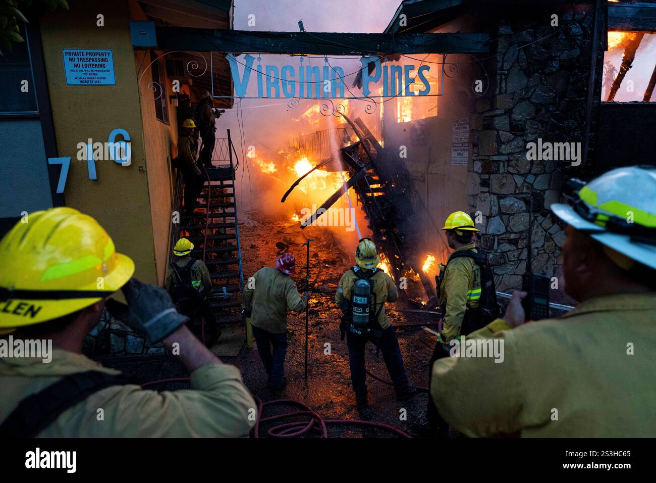 Long Beach FD Firefighters hose down a burning apartment building. The ...