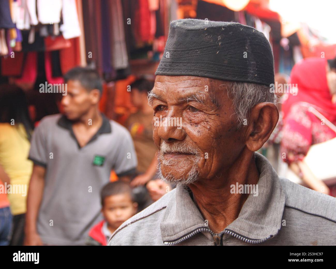 An elderly Minangkabau Indonesian man with a goatee wearing a songkok ...