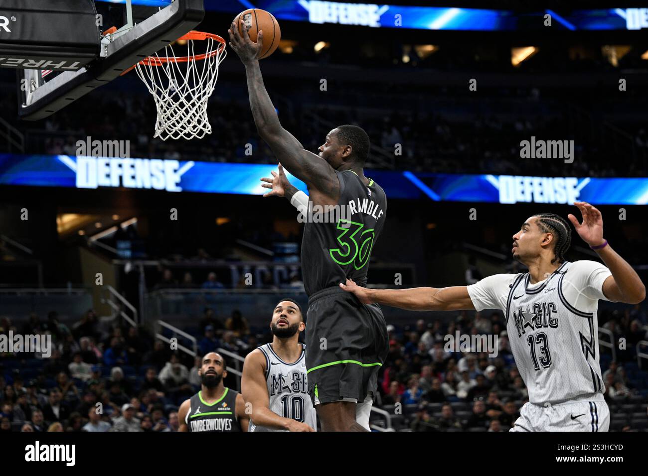 Minnesota Timberwolves forward Julius Randle (30) goes up to shoot between Orlando Magic guards ...