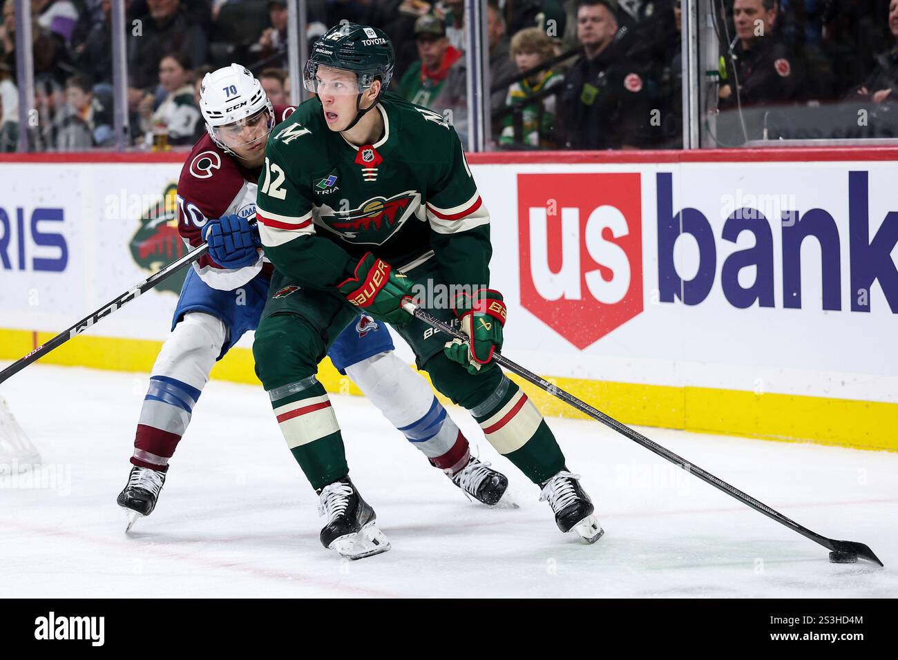Minnesota Wild left wing Matt Boldy, right, skates with the puck as ...