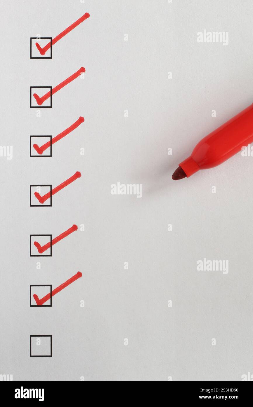Checklist boxes close up with red ticks and marker Stock Photo - Alamy