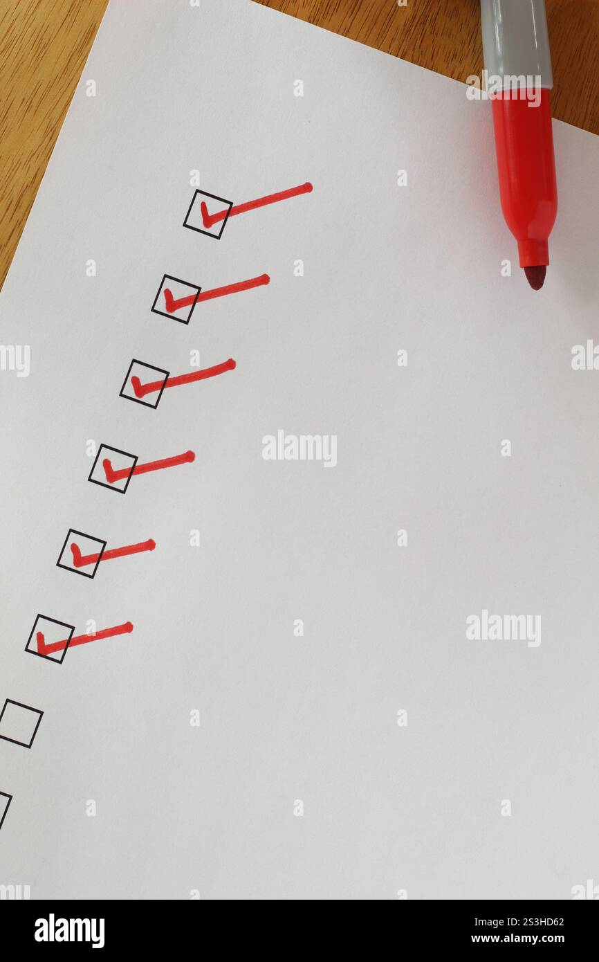 Checklist boxes close up with red ticks and marker Stock Photo - Alamy