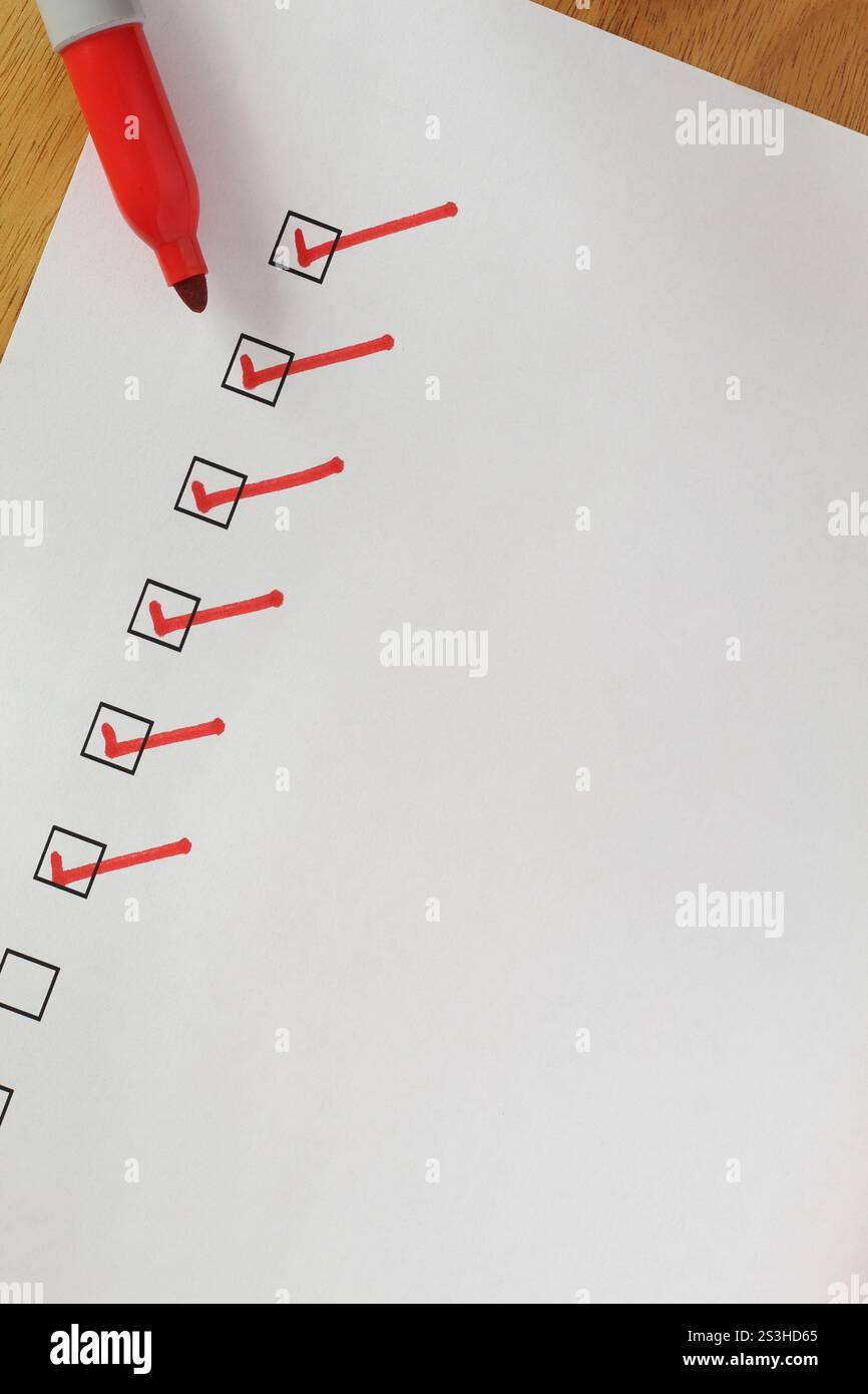 Checklist boxes close up with red ticks and marker Stock Photo - Alamy