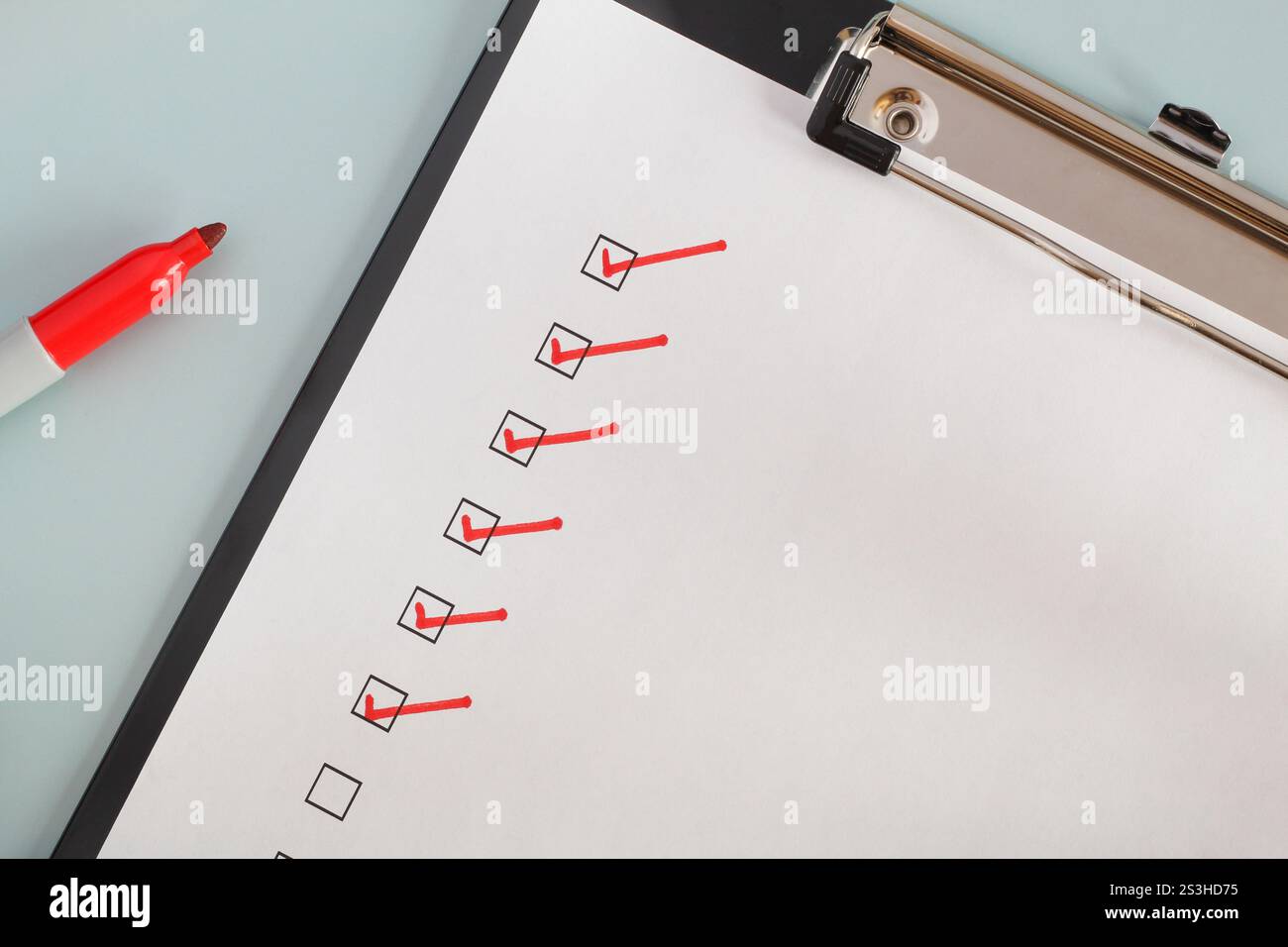 Checklist boxes close up with red ticks and marker Stock Photo - Alamy