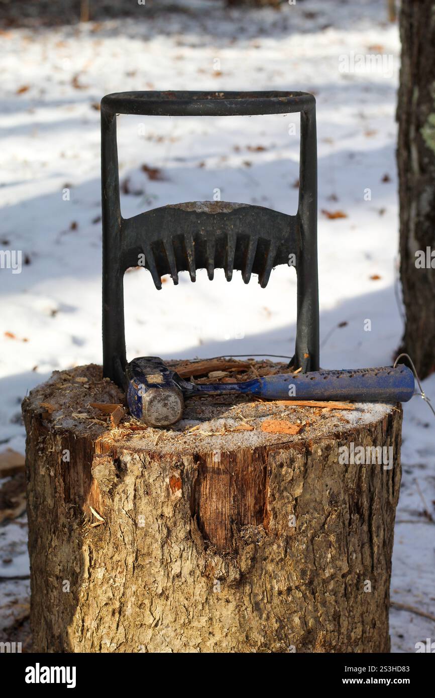 Log splitter and mallet in snow Stock Photo - Alamy
