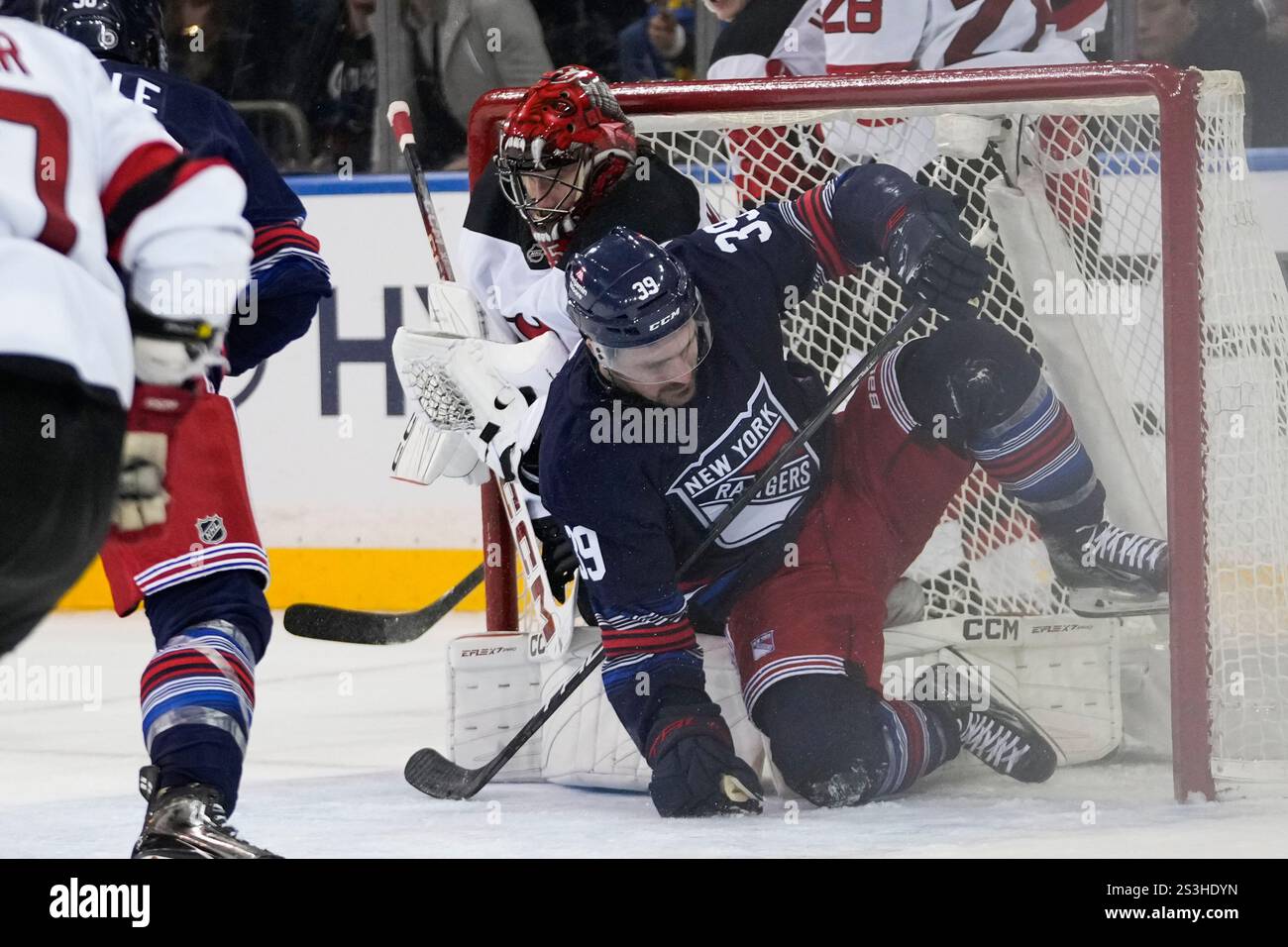 New York Rangers' Sam Carrick (39) slides into New Jersey Devils ...