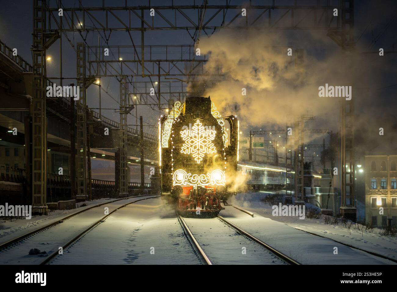 Retro Christmas steam train at night in the city on Christmas Eve and ...