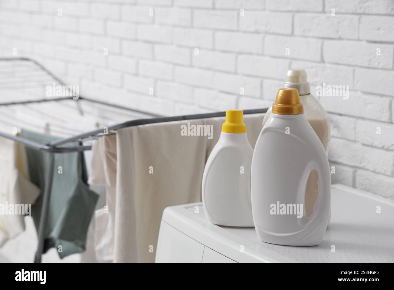 Bottles of detergent on washing machine in laundry room, closeup Stock ...