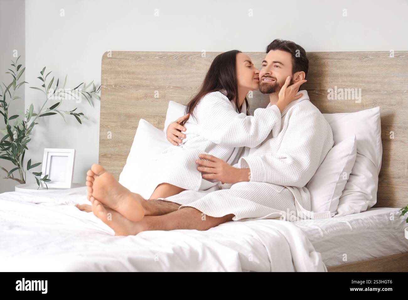 Morning of loving couple kissing in bedroom Stock Photo - Alamy