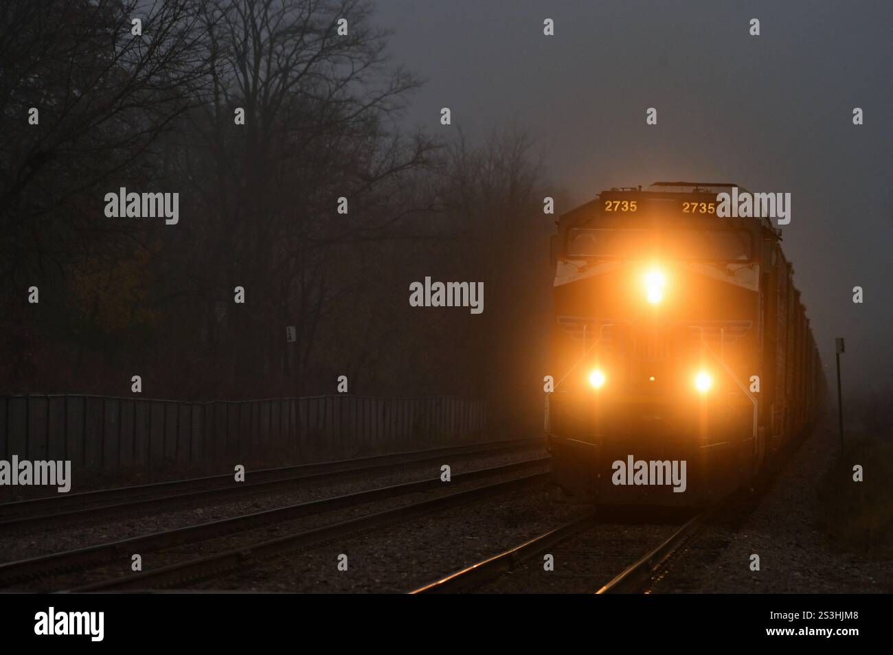 Glen Ellyn, Illinois, USA. The glow from the lights of the lead ...