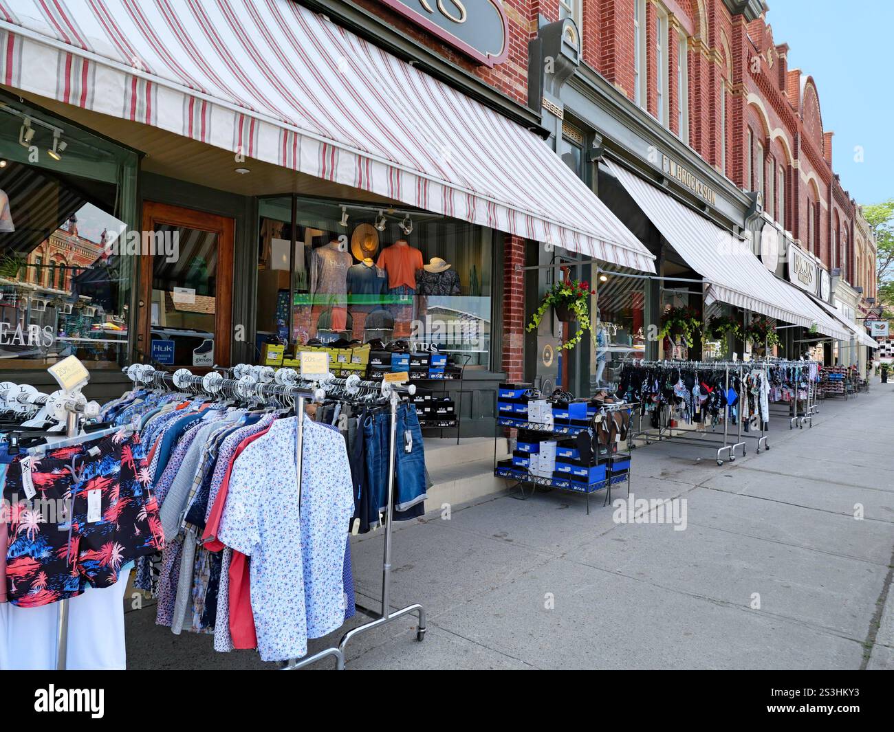 Small town main street with stores displaying their merchandise outdoor ...