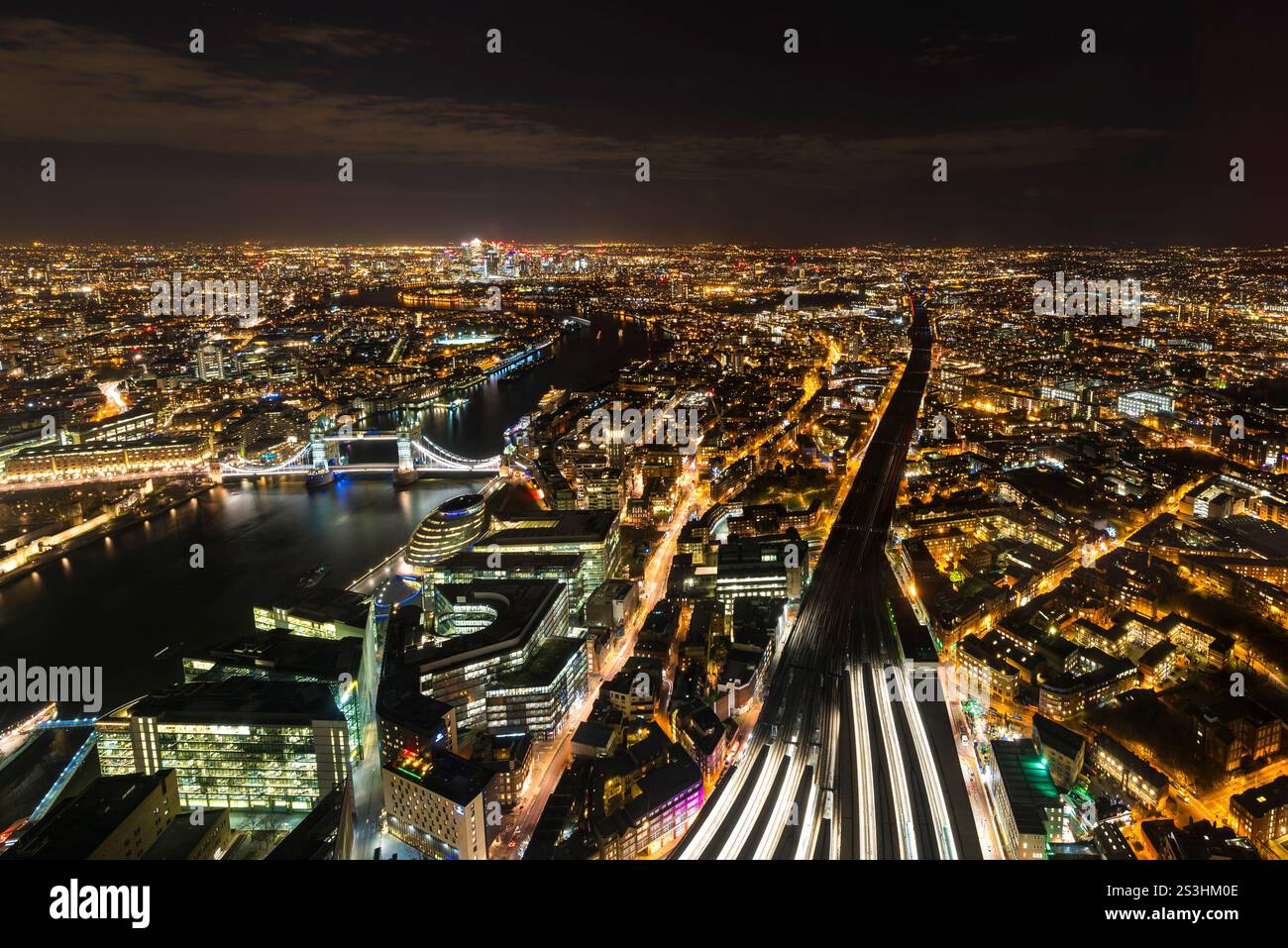 Aerial Nighttime View of London Skyline with Tower Bridge Illuminated ...