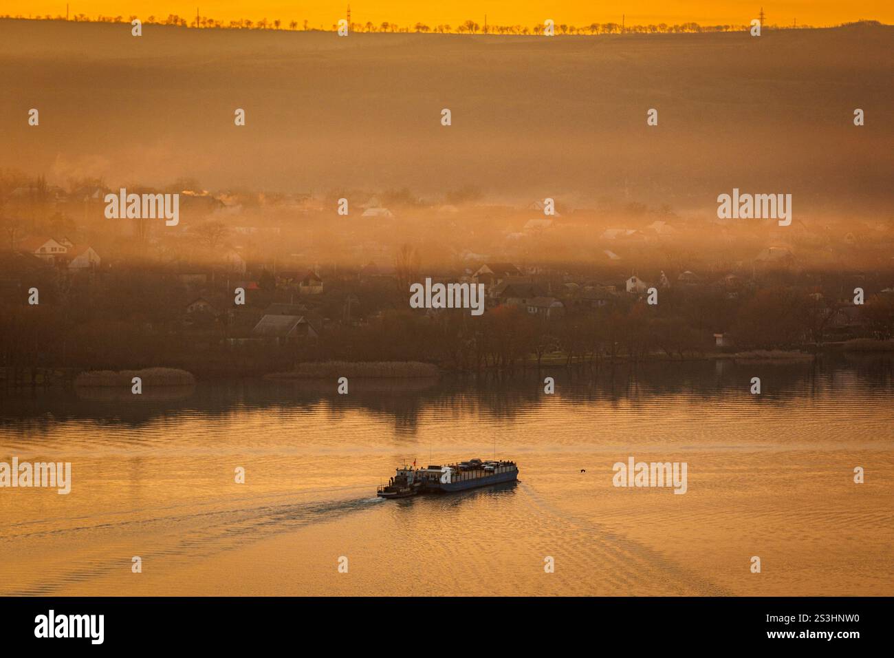 A ferry sails to the left bank of the Dniester river, the border ...