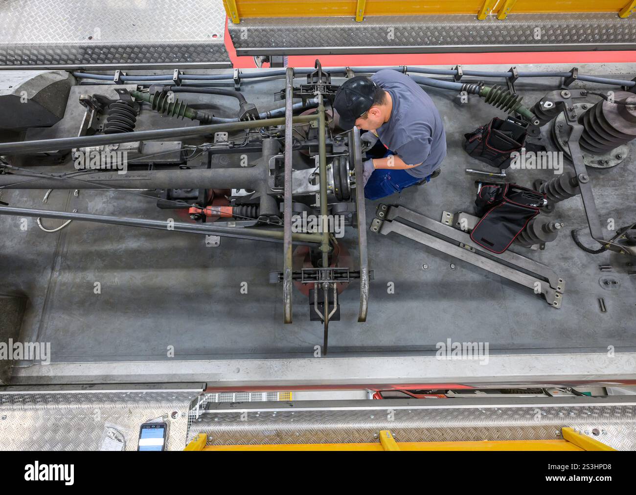 PRODUCTION - 09 January 2025, Brandenburg, Cottbus: A worker repairs a ...