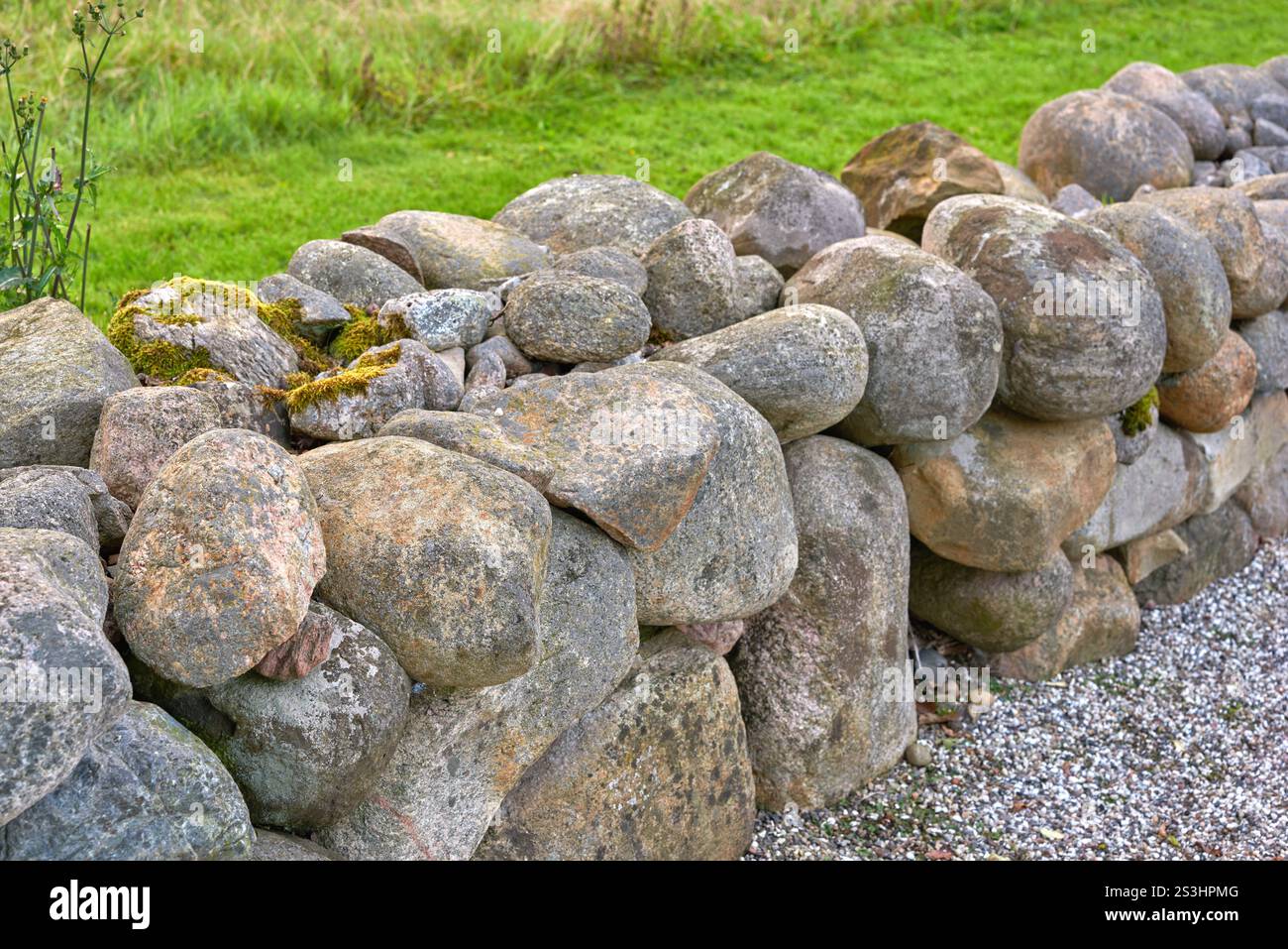 Grass, stone wall and outdoor on property for landscaping, garden ...
