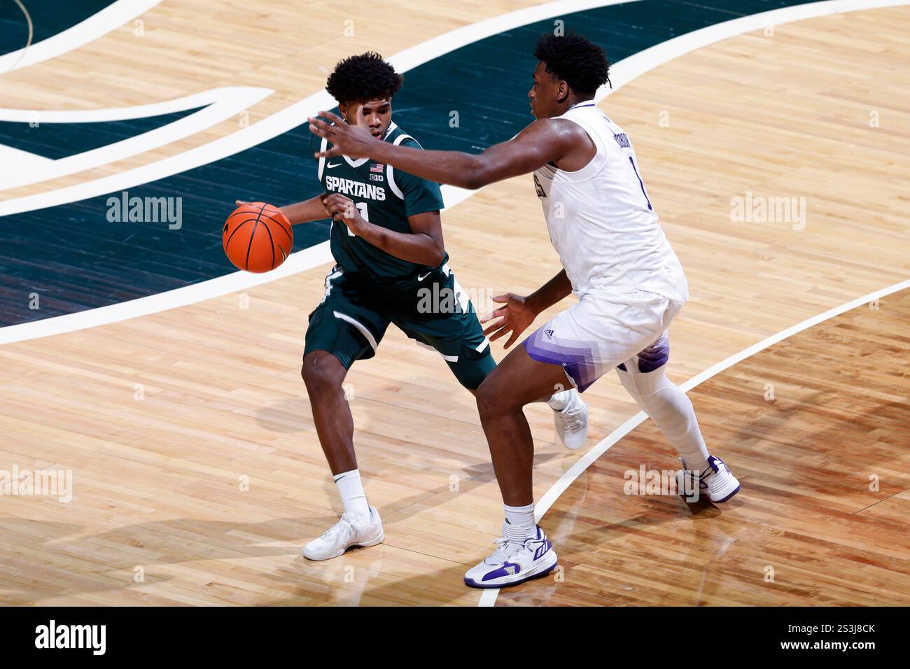 Michigan State guard Jase Richardson, left, drives against Washington ...