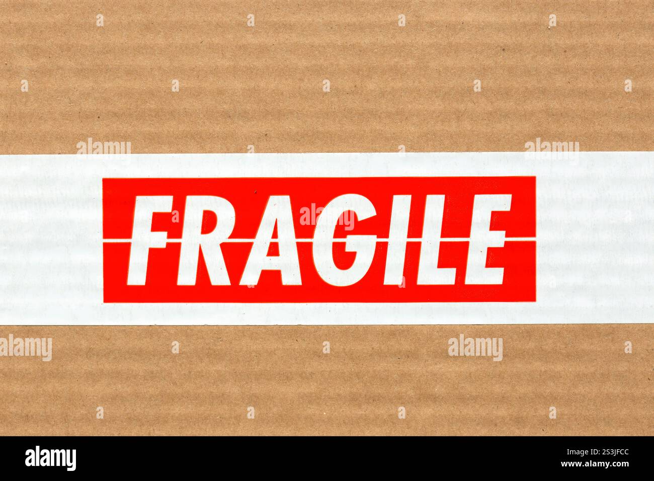 Fragile tape stuck across a cardboard box. Business and industrial ...