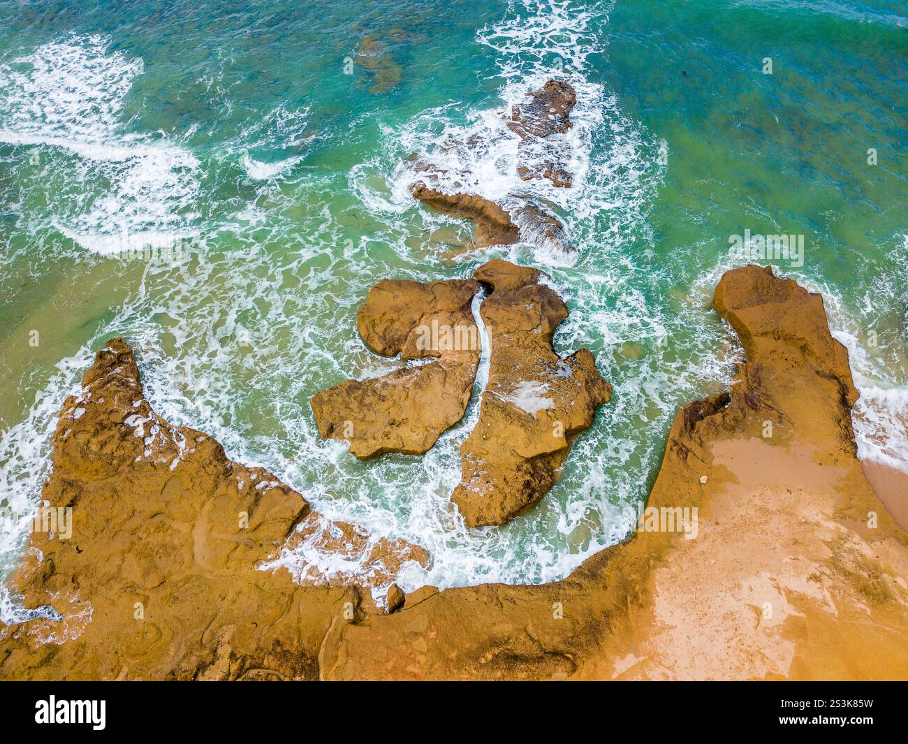 Aerial view of waves breaking on rocky ledges at Aireys Inlet on the ...