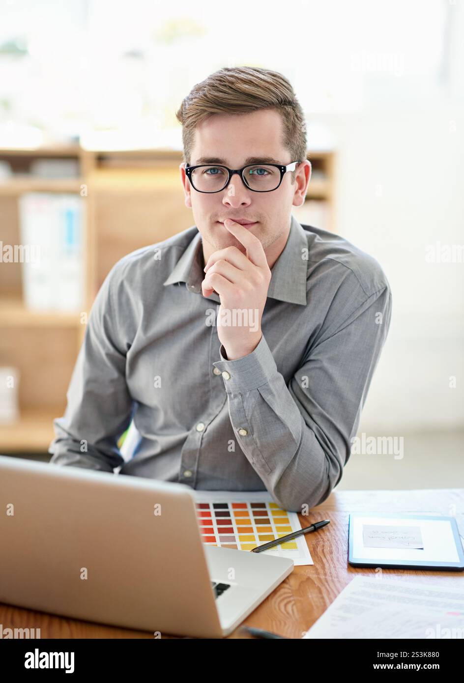 Man, laptop and color palette in office at startup, portrait and problem solving at graphic ...