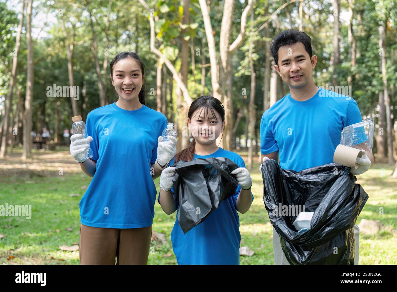 Proud family showcasing their efforts after a successful garbage ...