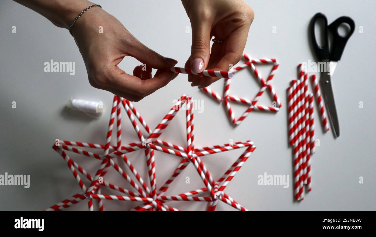 Hand made. Female hand holds needle with thread. In the process of ...
