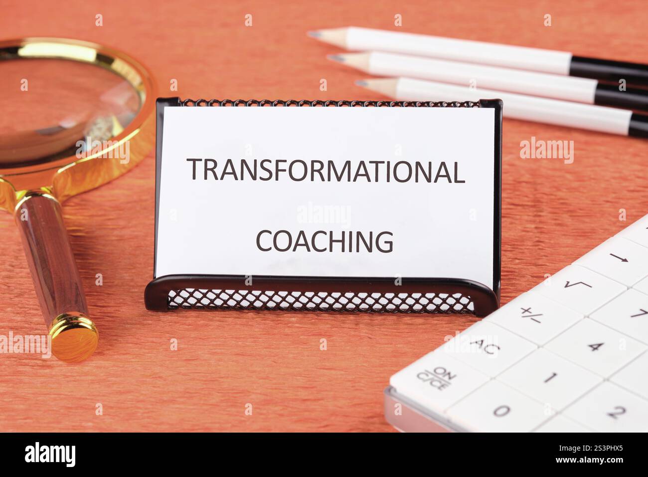 Business and technology concept. The TRANSFORMATIONAL COACHING concept phrase written on a ...