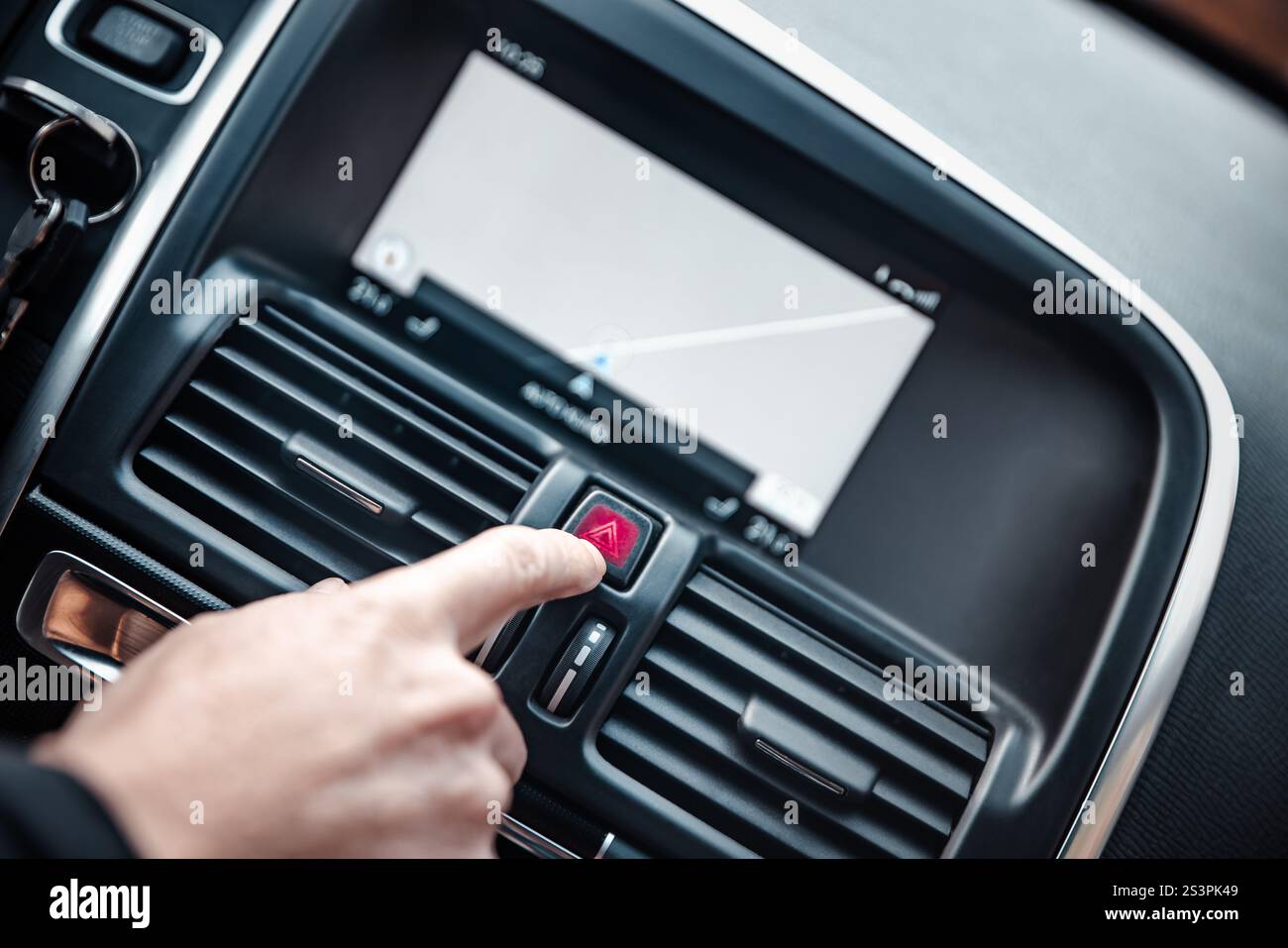 Hand pressing Hazard warning lights button, red triangle button in car ...