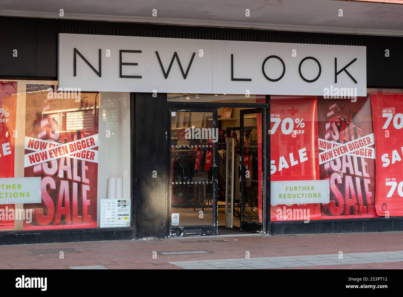 Entrance and front of a New Look store with big sale signs in the ...