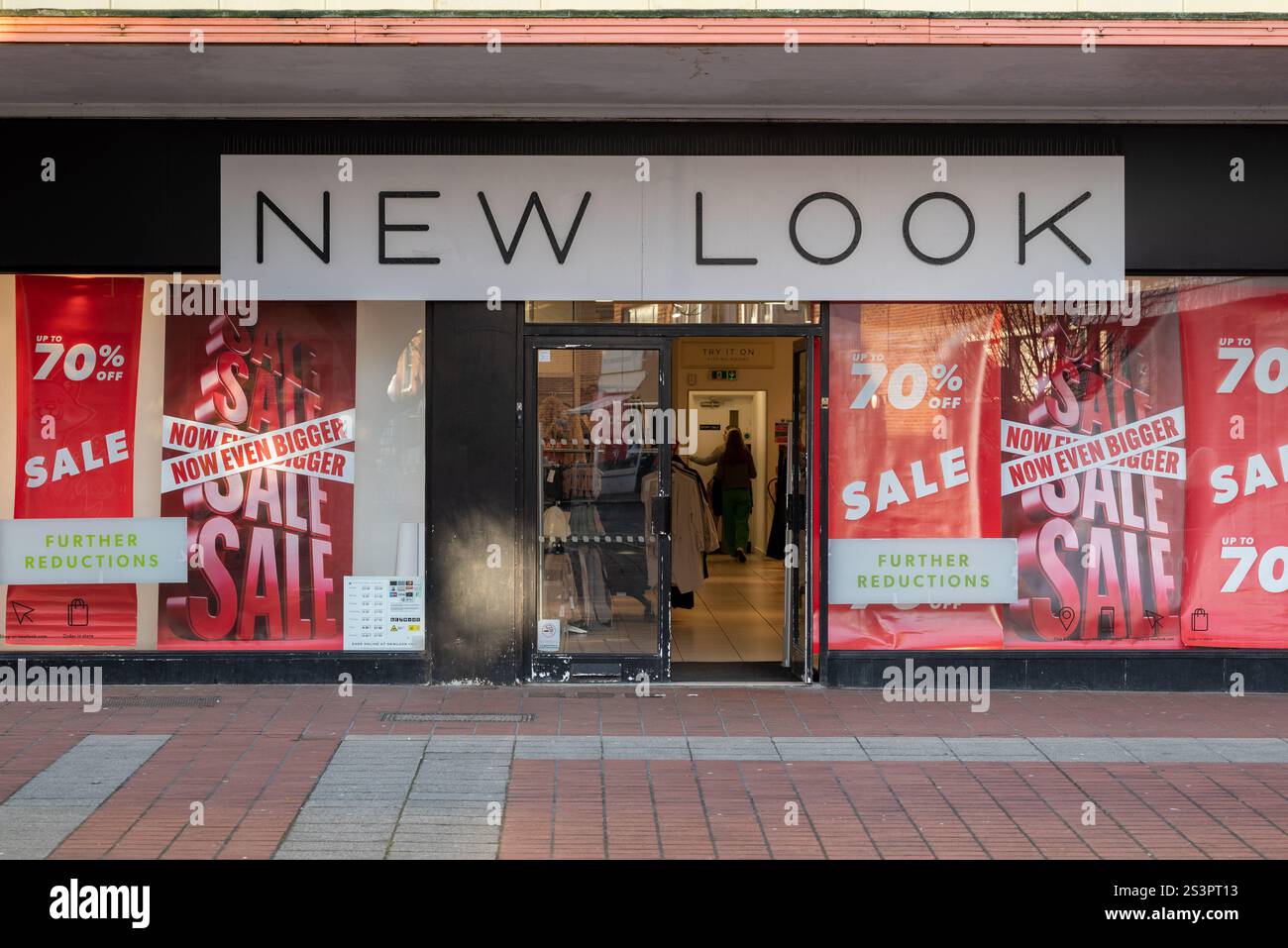 Entrance and front of a New Look store with big sale signs in the ...