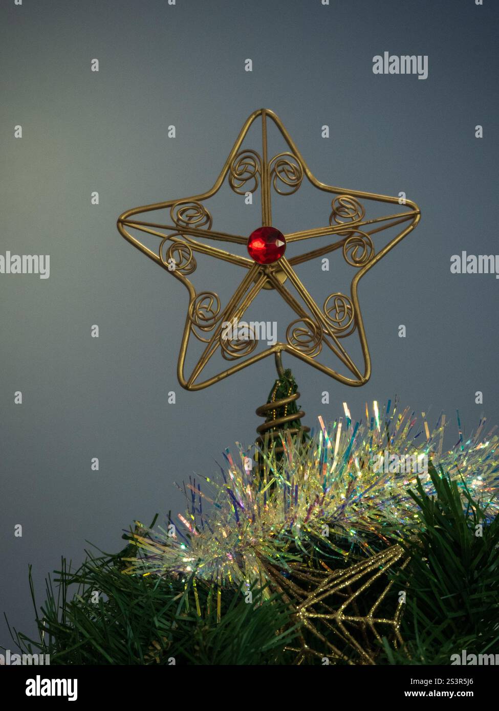 Star at the top of the Christmas tree with a red jewel-like glass stone ...