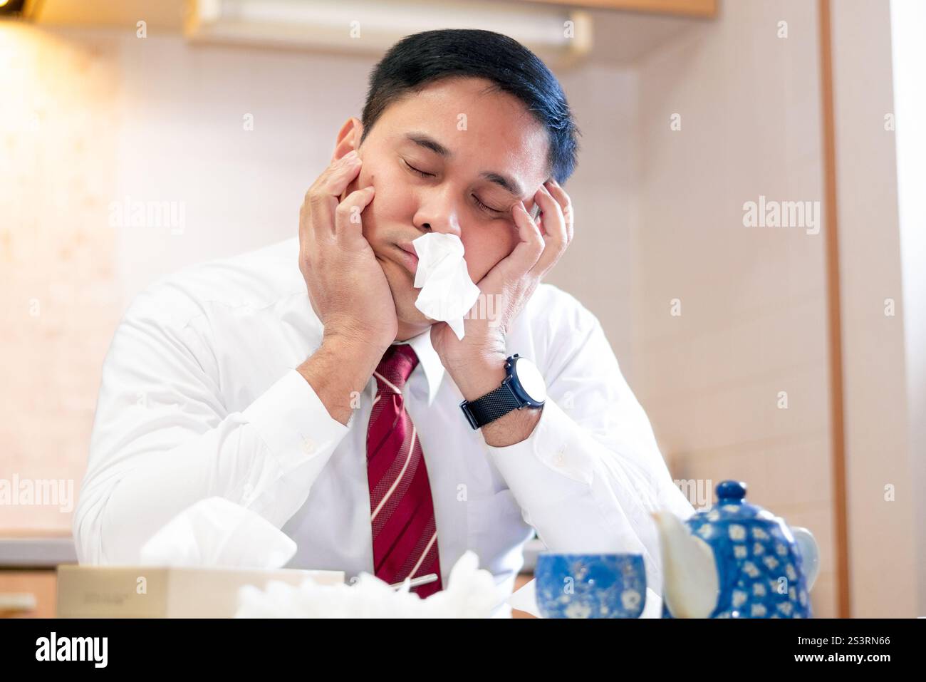 Man with flu and headache, allergy, tissue preventing runny nose and ...