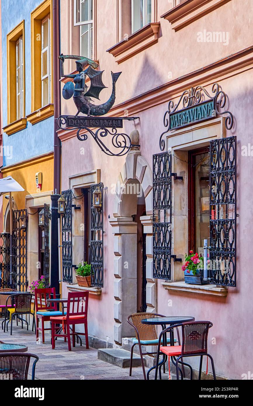 Wrought-iron signage outside shop on side of building in the old ...