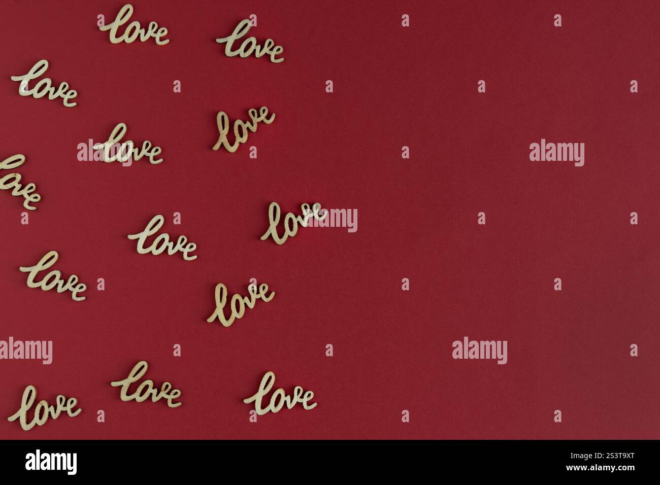 Red cardboard background with word LOVE in wooden letters and hearts ...