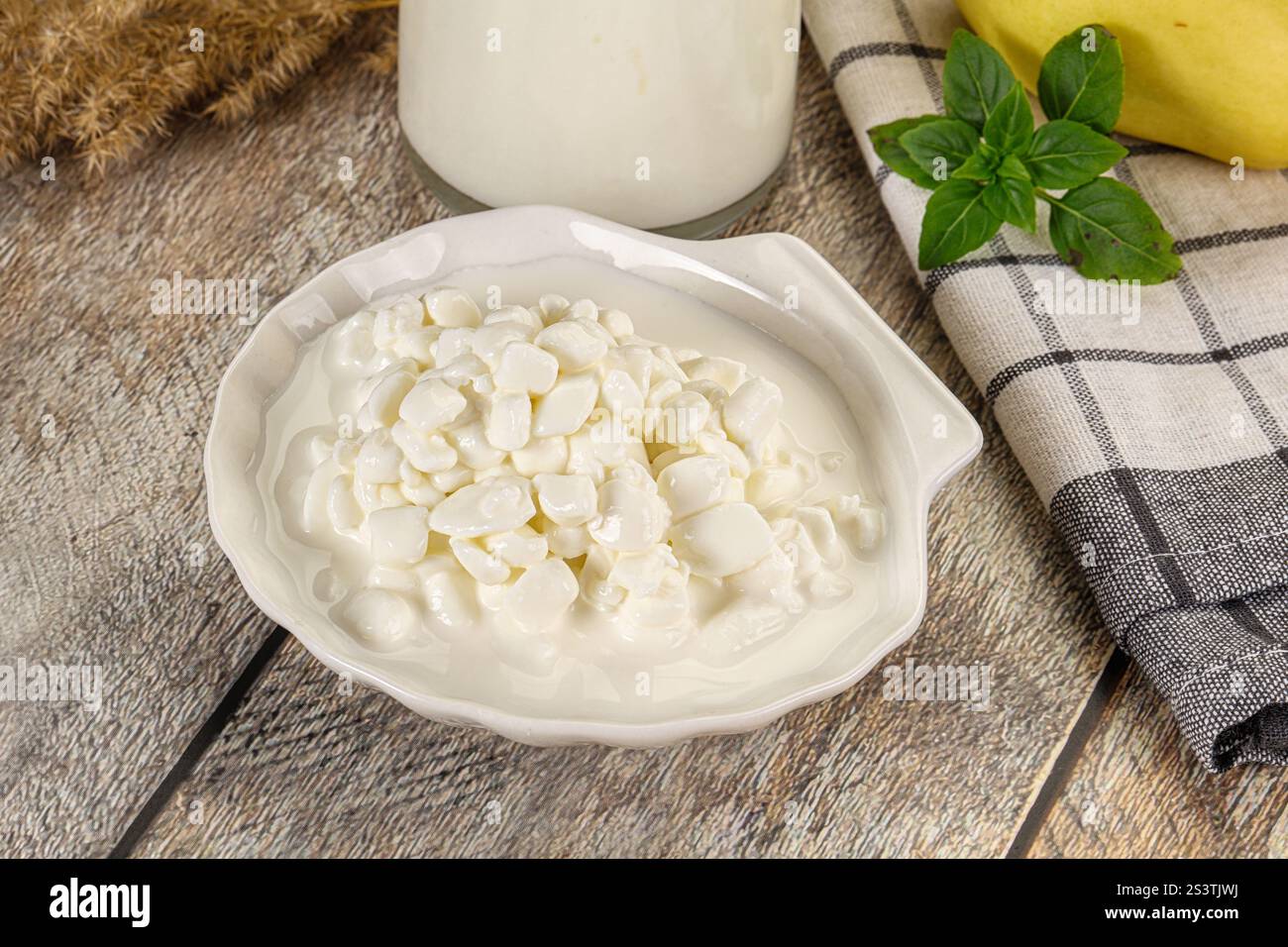 Grain cottage cheese with sour in the bowl Stock Photo - Alamy