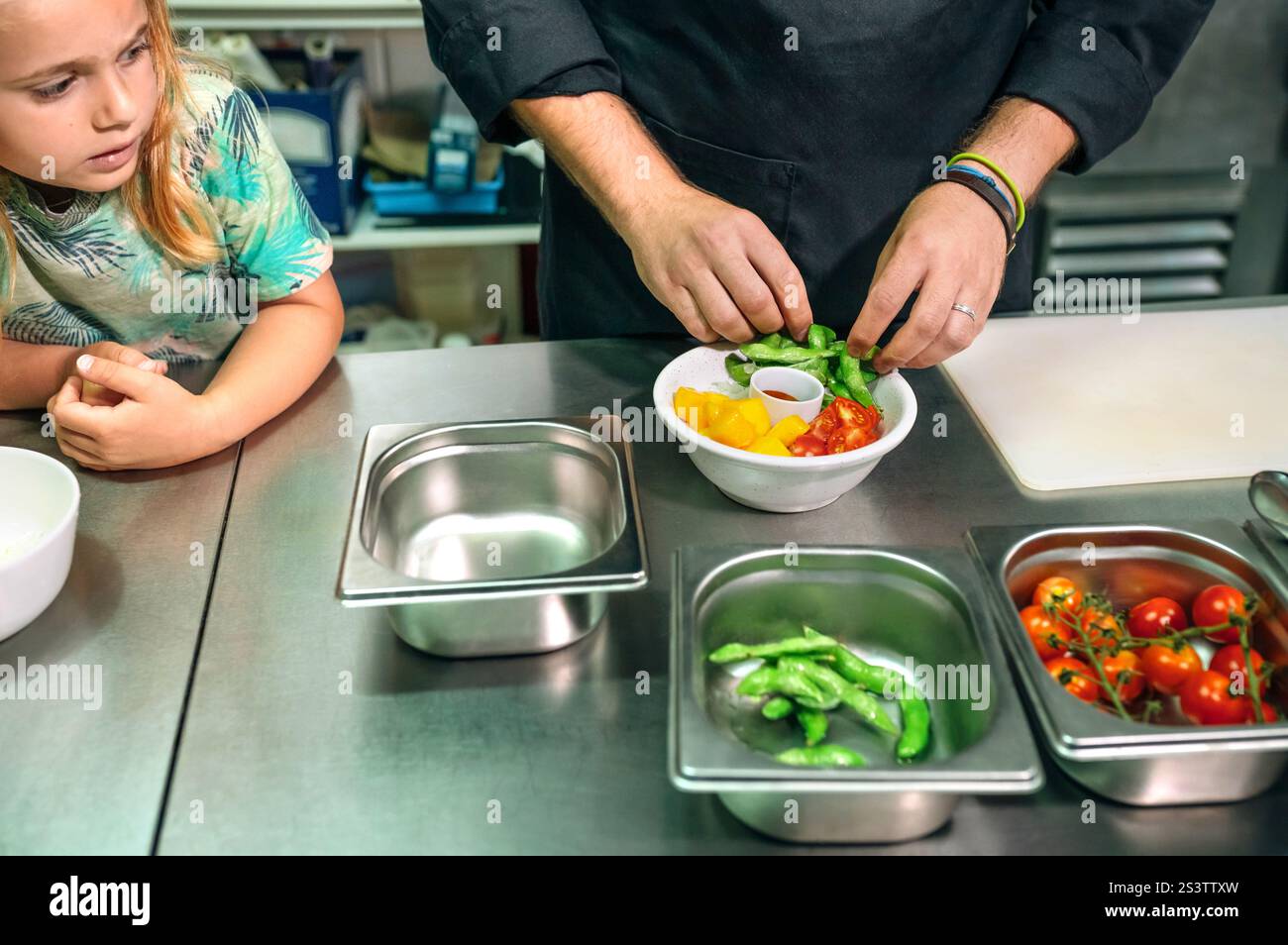 Close up of unrecognizable chef carefully preparing a vegan poke bowl ...