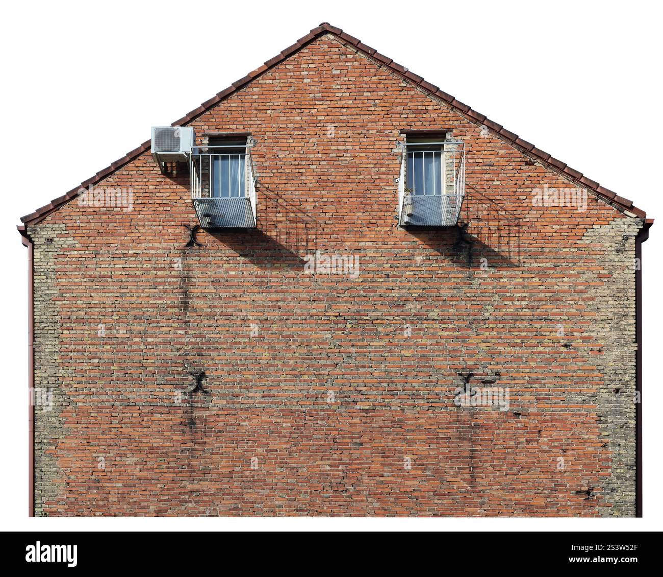 Side wall of an old red brick house with two balconies. Isolated on ...