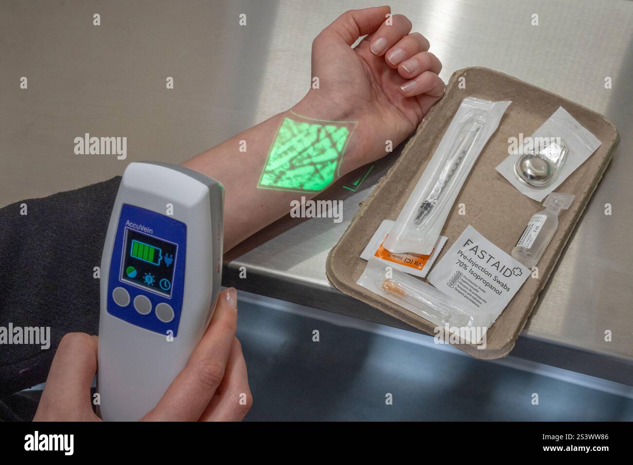 A member of staff demonstrates an AccuVein vein finding device at The ...