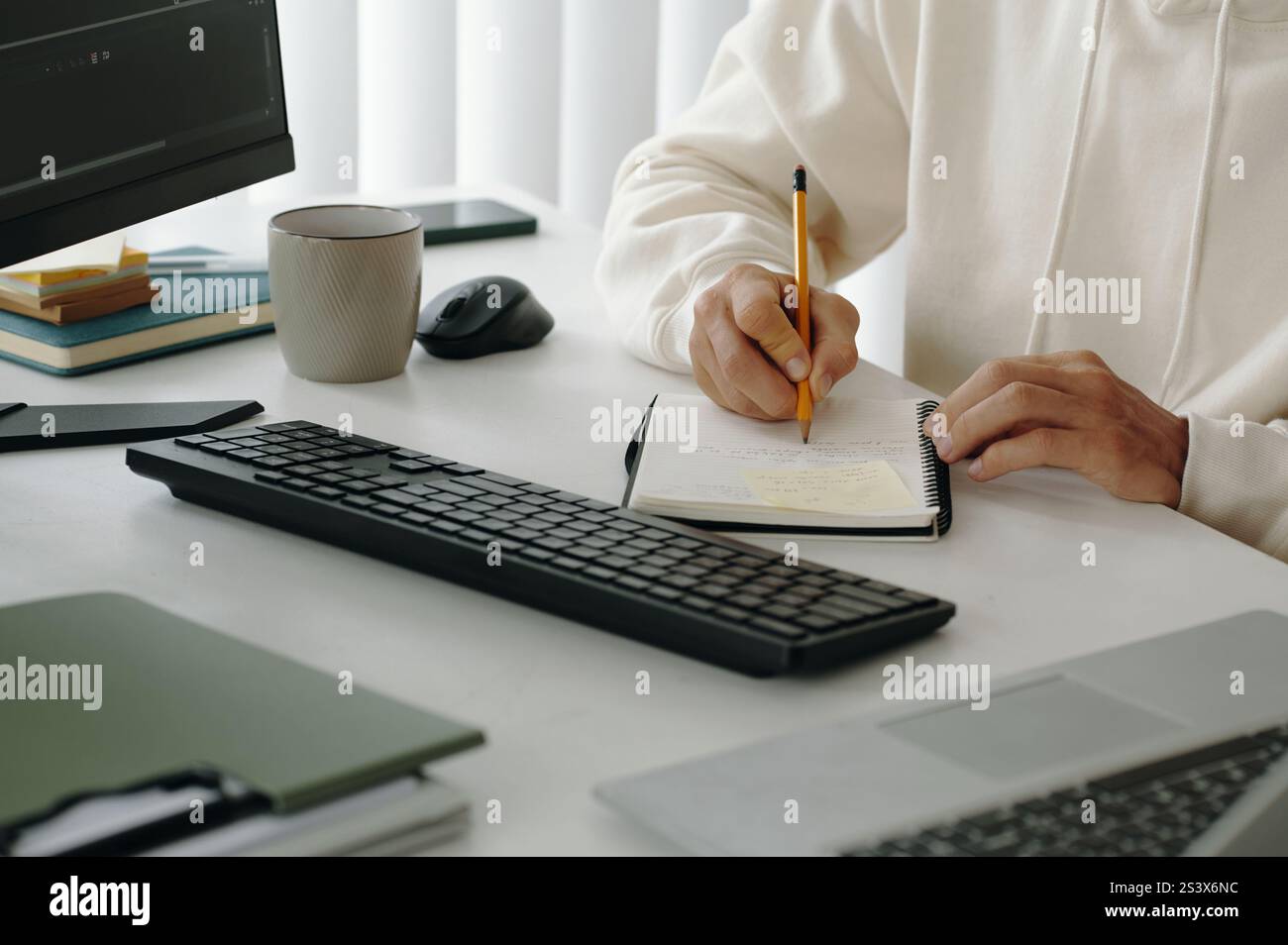 IT Programmer Making Notes In Notepad Stock Photo - Alamy