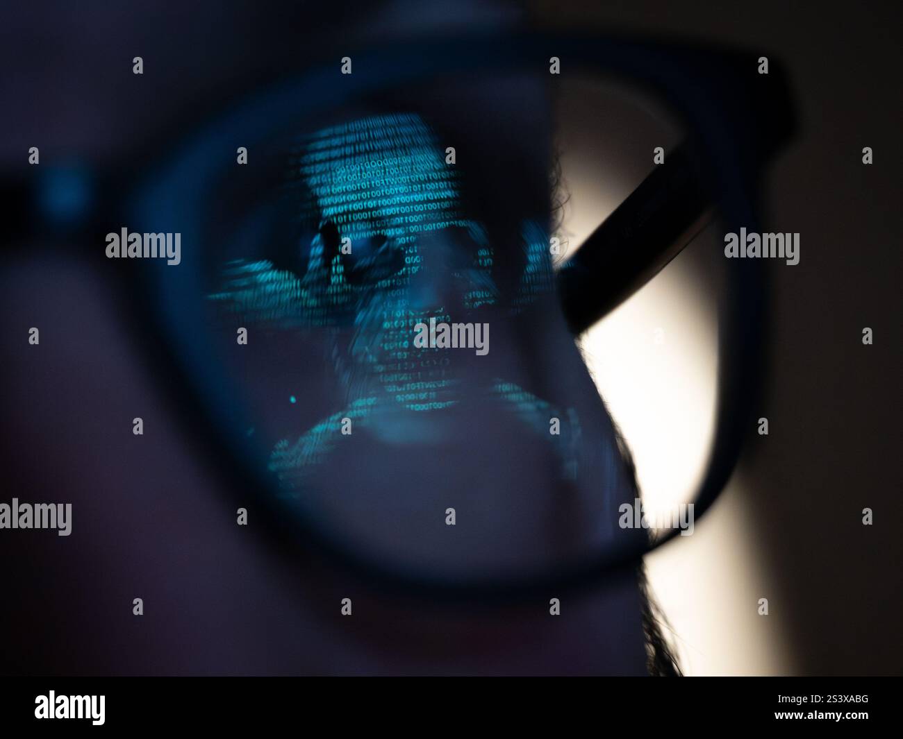 An hackers ASCII skull and crossbones image reflected in the lens of a ...