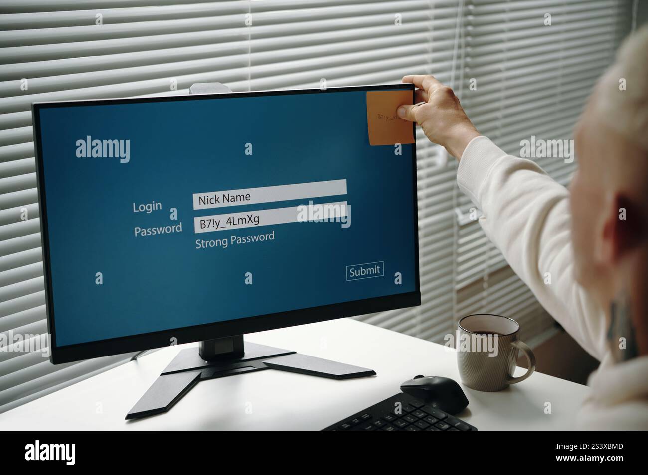 Programmer sticking note with password on computer monitor while ...