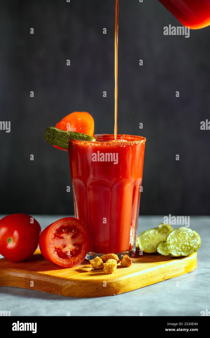 Refreshing vegetable cocktail. Tomato juice served in glass with ...