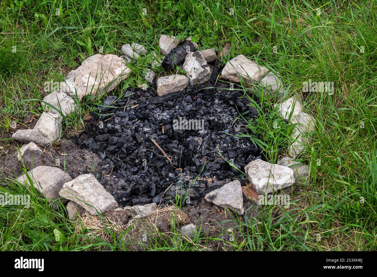 The circle of stones contains blackened ash and charcoal remnants from ...