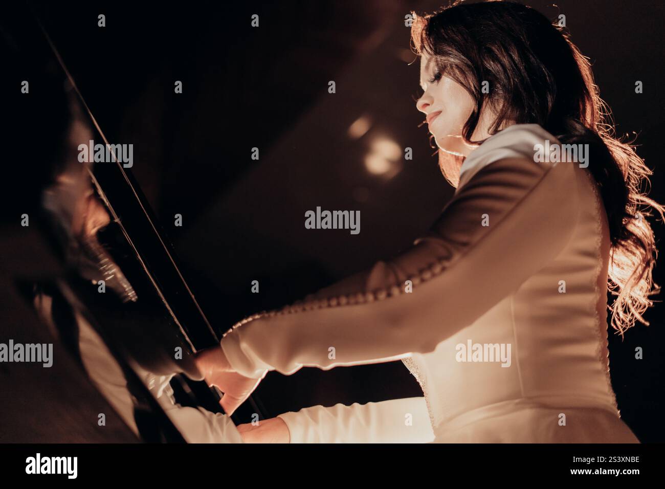 Elegant Pianist Performing Under Stage Lights Stock Photo - Alamy