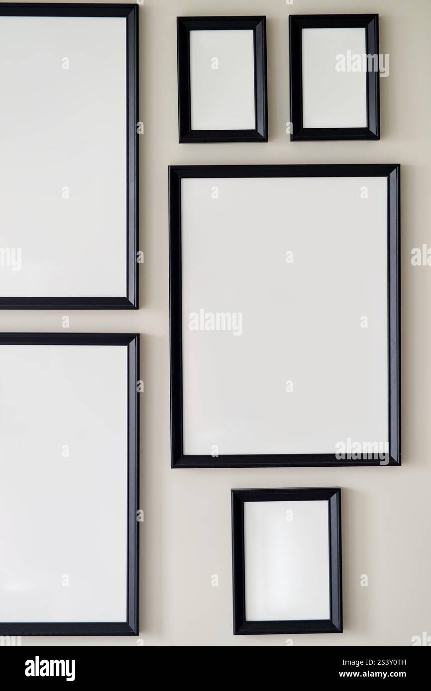 Different size framed photos hanging on the gray wall. Mockup Stock ...
