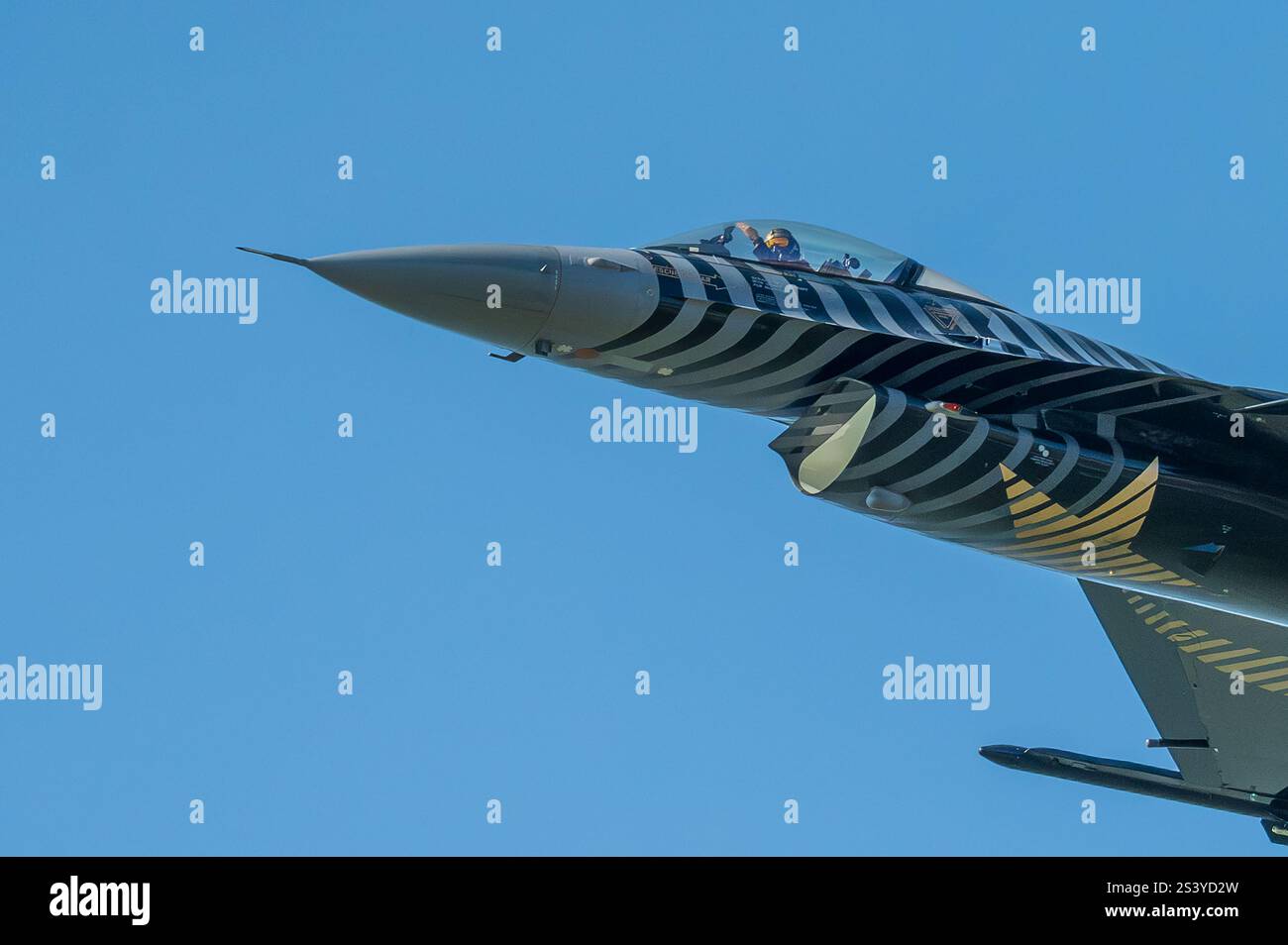 close-up of a fighter jet in flight, pilot inside the cockpit is ...